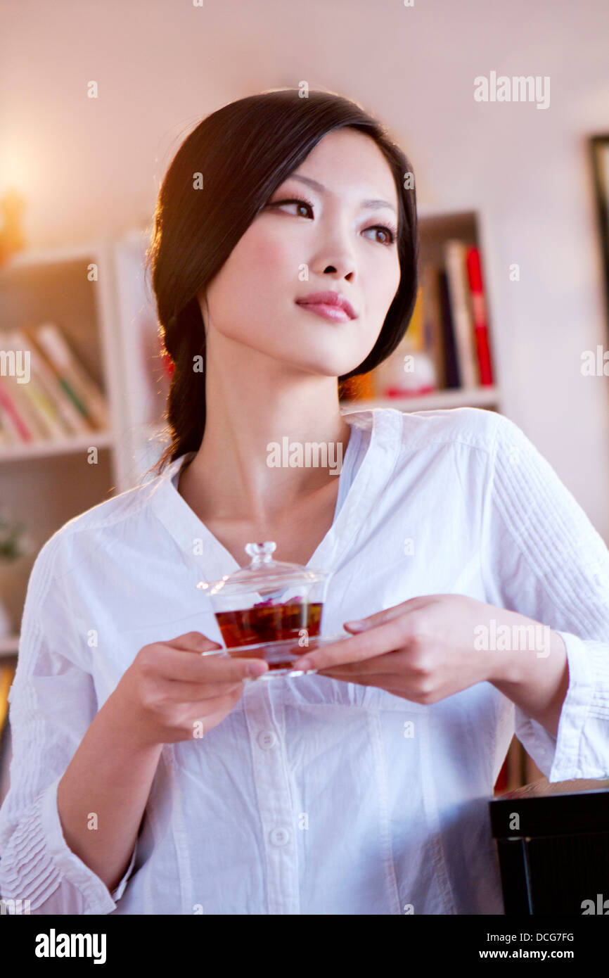 The young woman drinking tea Stock Photo - Alamy