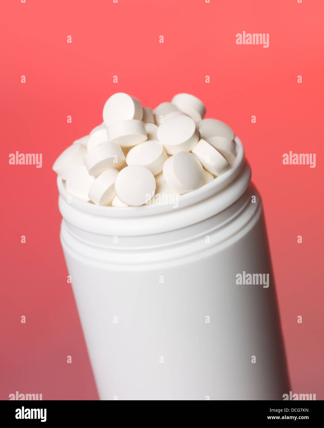 Stack of pills towards red background Stock Photo - Alamy