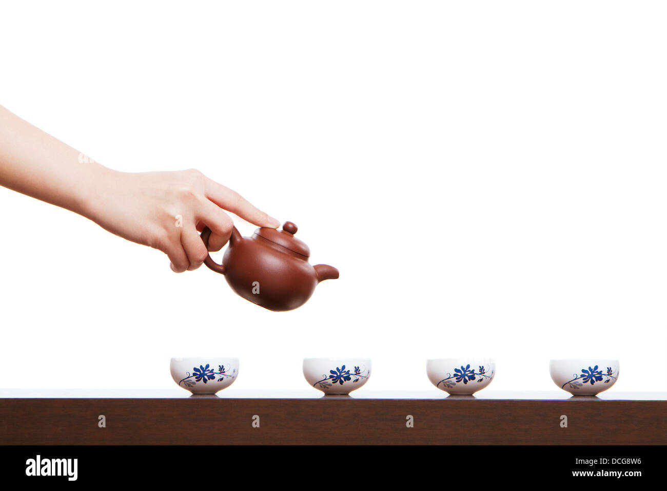 A hand in pouring tea closeup Stock Photo - Alamy
