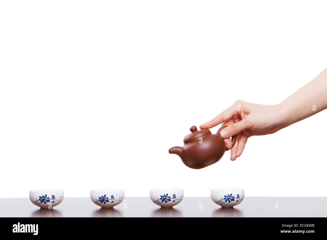 A hand in pouring tea closeup Stock Photo - Alamy