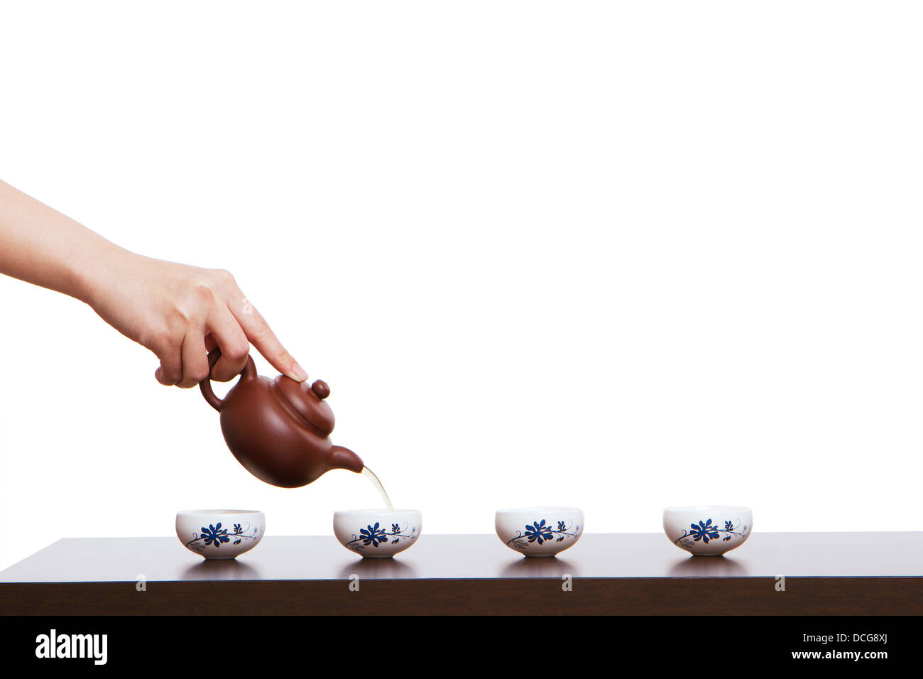 A hand in pouring tea closeup Stock Photo - Alamy