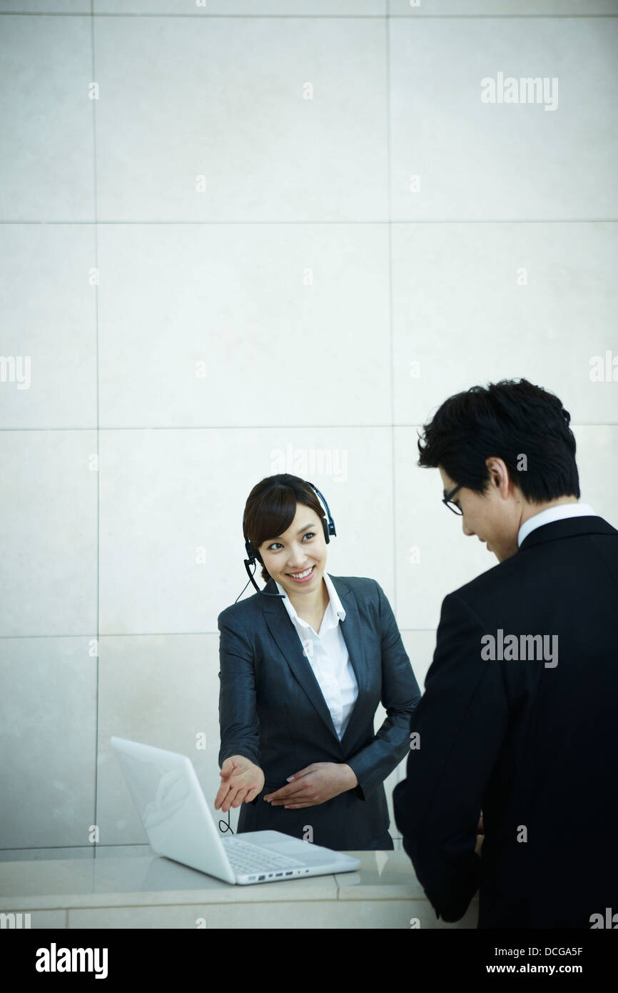 Businessman talking female receptionist hi-res stock photography and ...