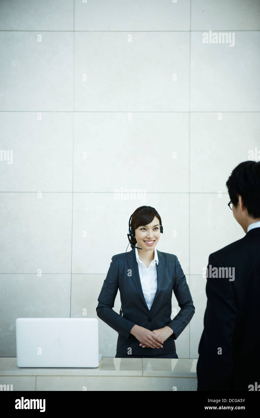 a business man talking to the receptionist Stock Photo - Alamy