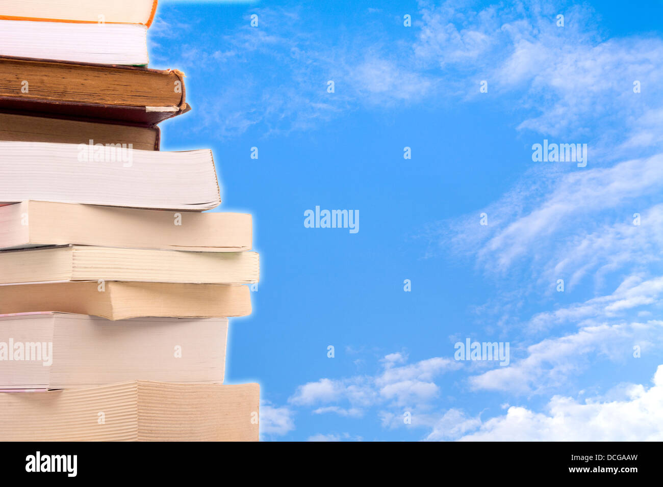 Old books in a stack with sky background Stock Photo - Alamy