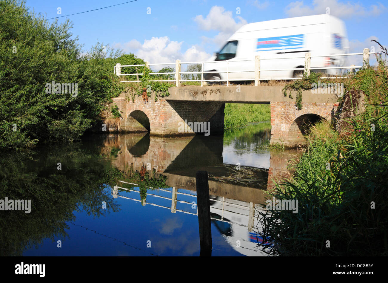 A white van crossing a narrow bridge over the River Bure in the Norfolk ...