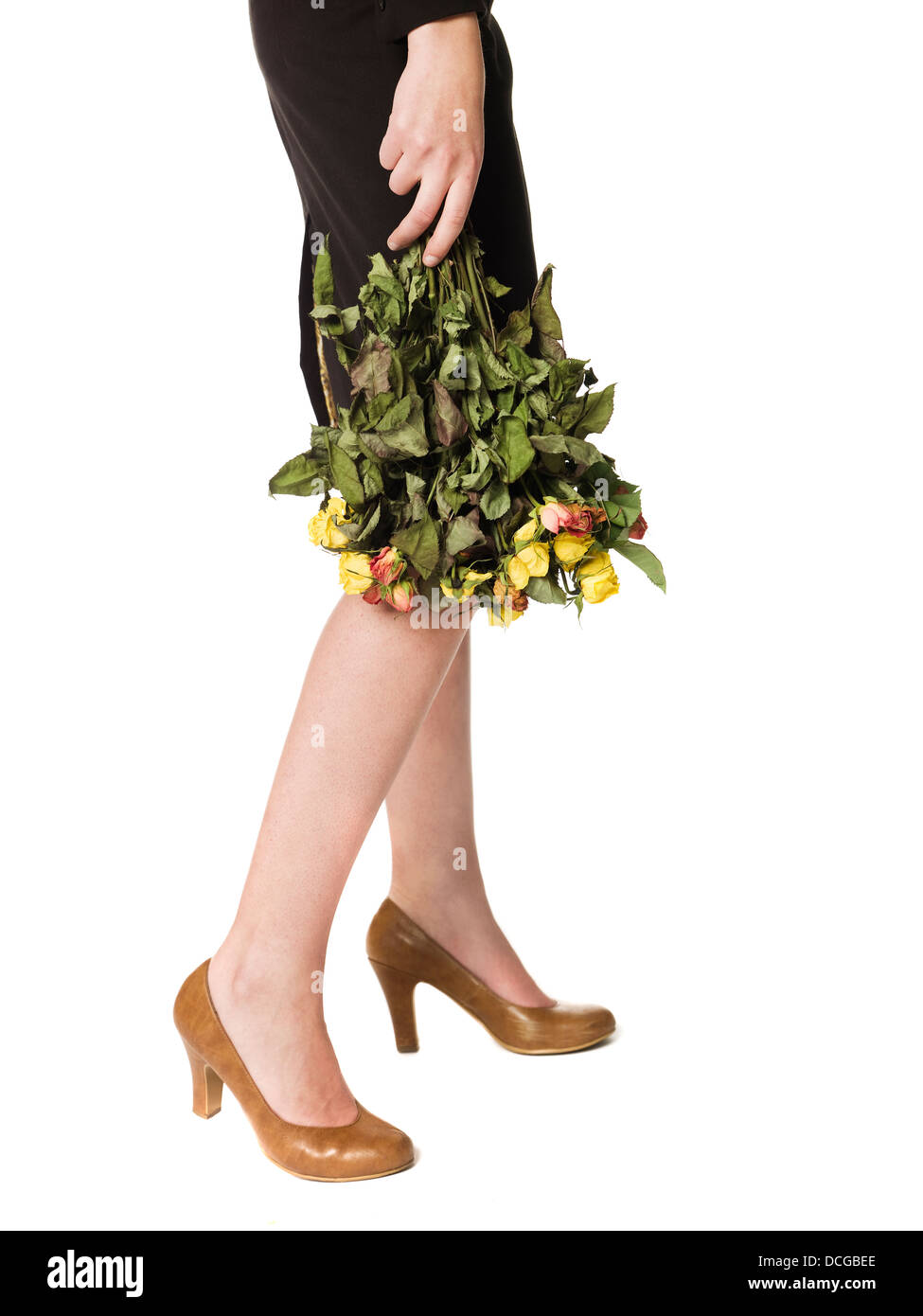 Woman holding a bunch of dead flowers Stock Photo - Alamy