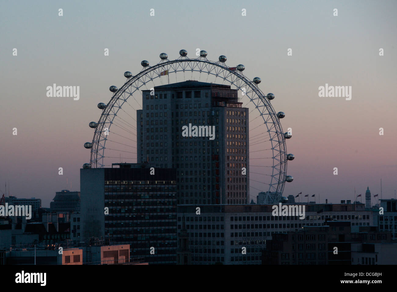 The London Eye is pictured behind the Shell Building in central London ...