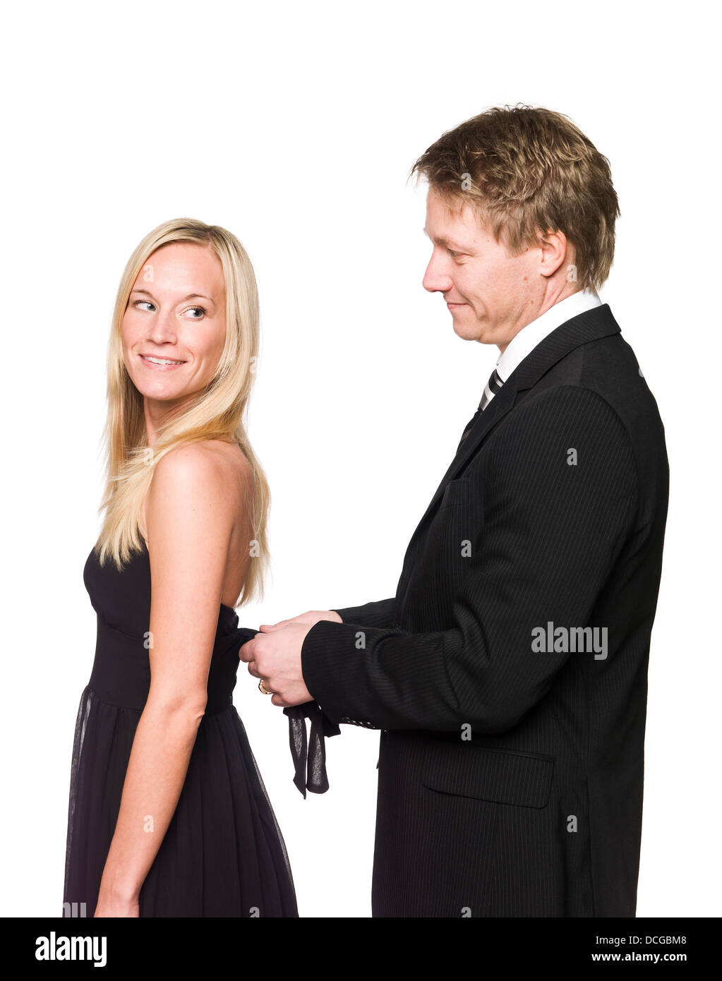 man helping woman to get dressed Stock Photo - Alamy