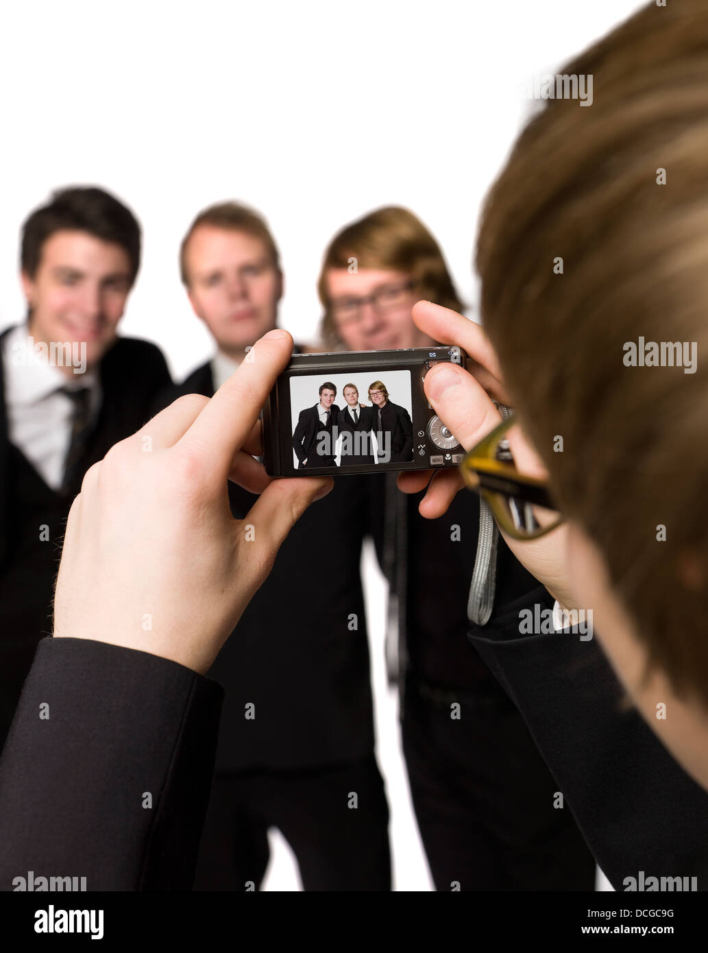 Man taking photos of his friends Stock Photo - Alamy
