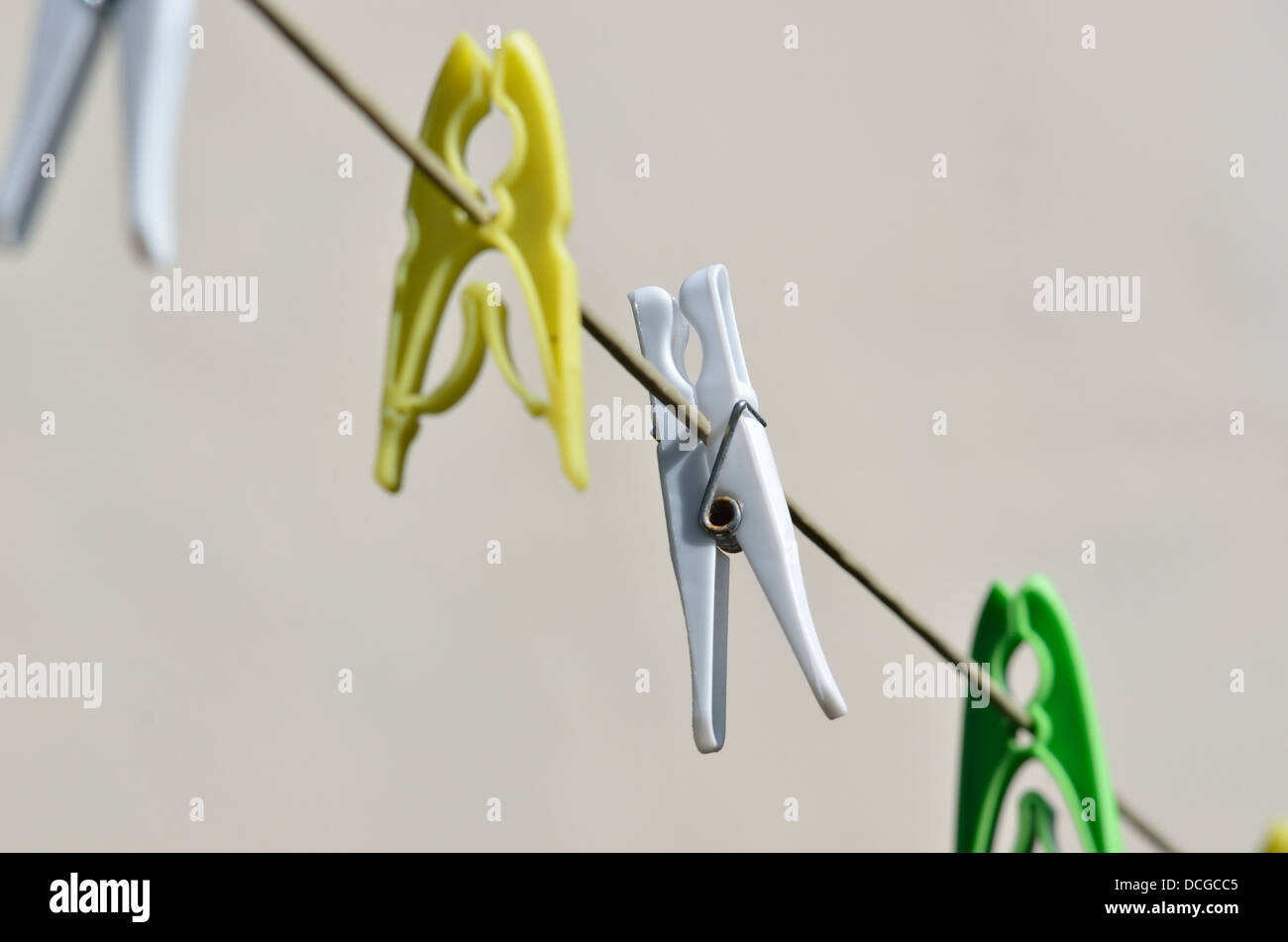 Assorted clothes pegs on a washing line Stock Photo - Alamy