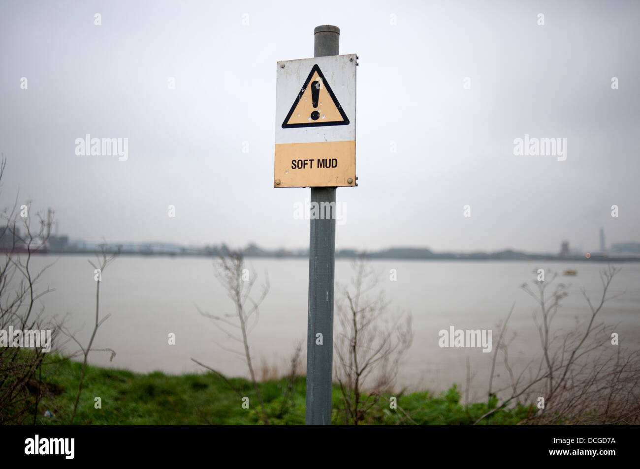 A 'soft mud' sign is pictured on the bank of the River Thames Stock ...