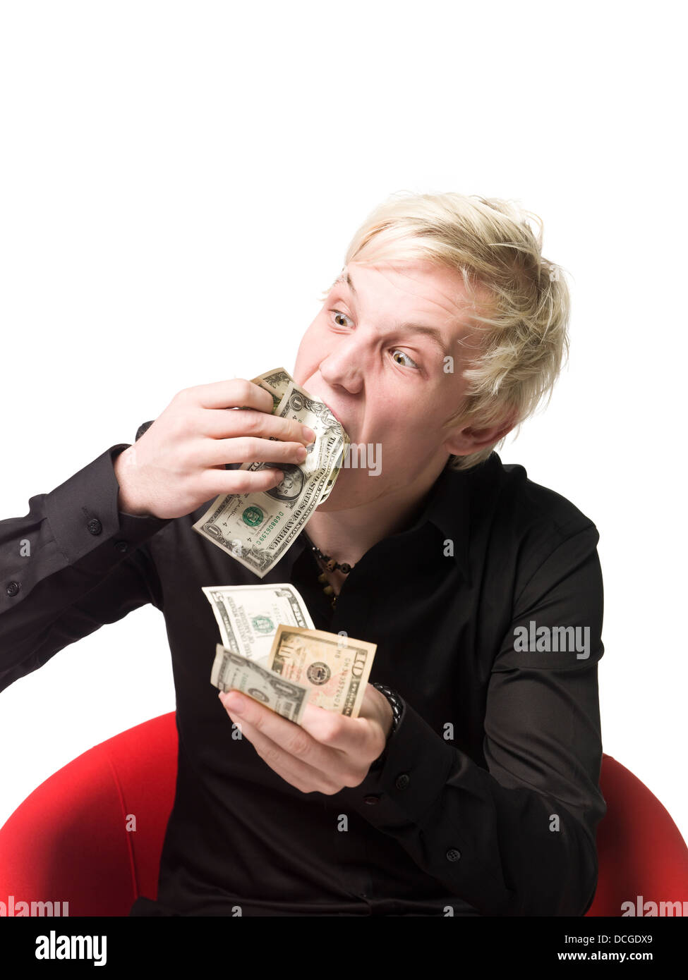 Boy eating money Stock Photo - Alamy