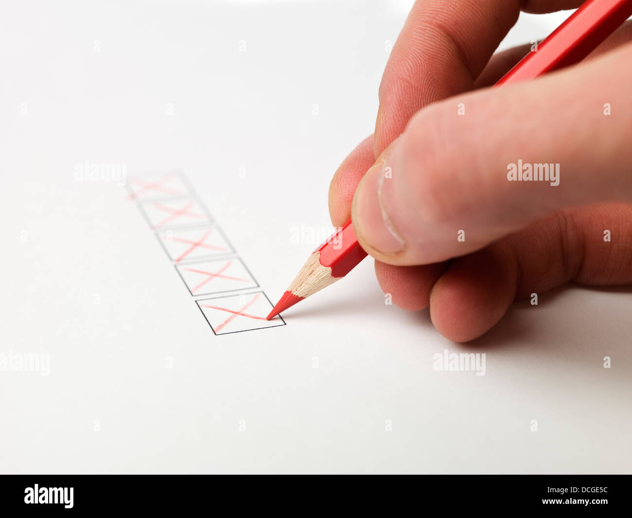Hand filling check boxes Stock Photo - Alamy