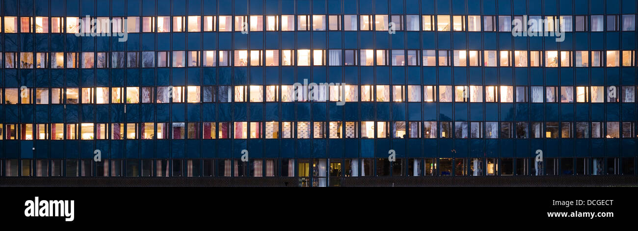 Windows glowing in the night on an office building Stock Photo - Alamy