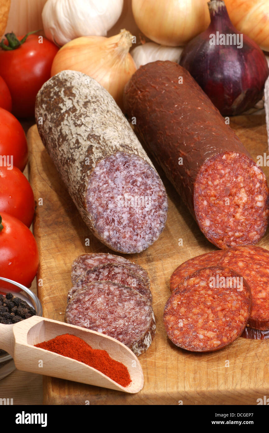salami and some slices salami on a timber board Stock Photo - Alamy