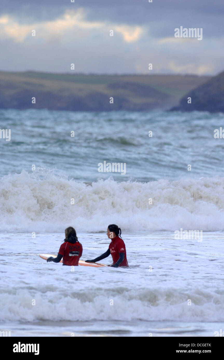 Surfers make their way out to enjoy the waves Stock Photo - Alamy