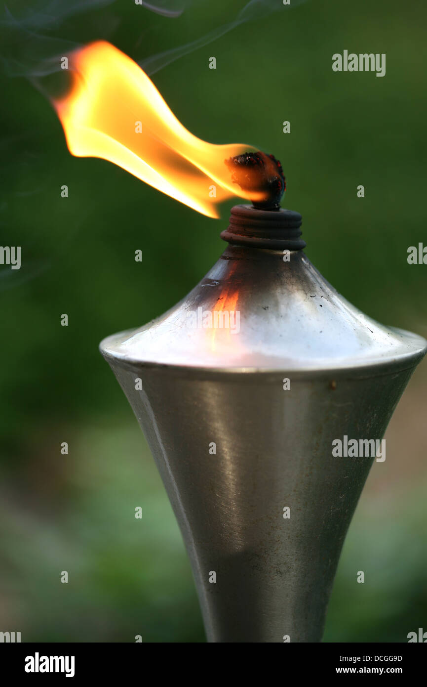 Lit torch with orange flame Stock Photo - Alamy