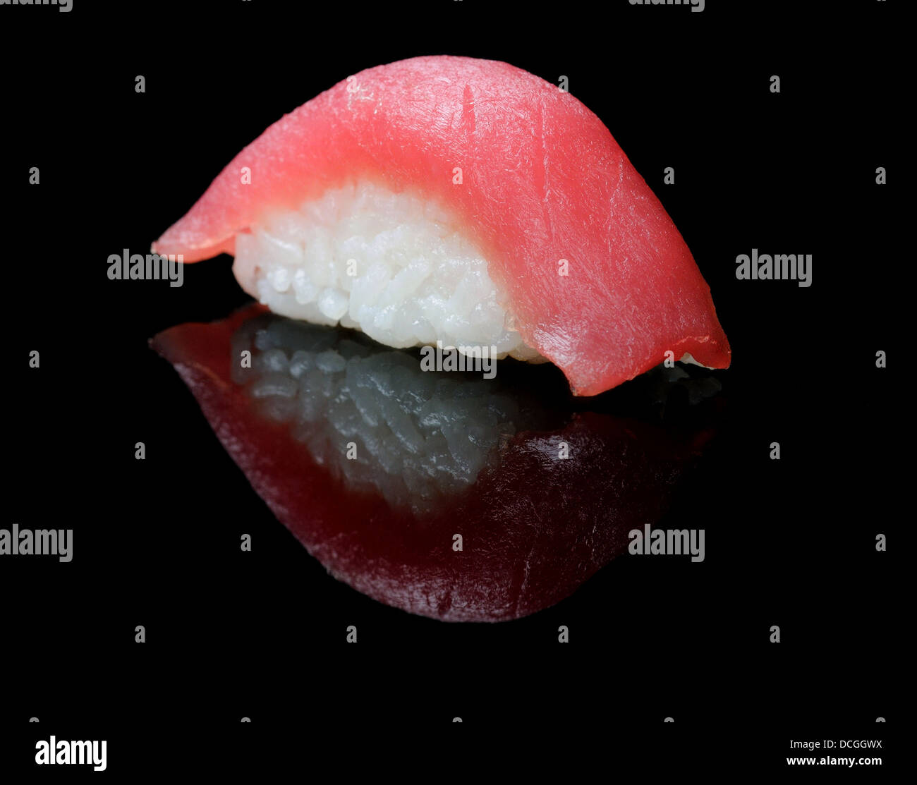 One tuna sushi on black reflecting background Stock Photo - Alamy