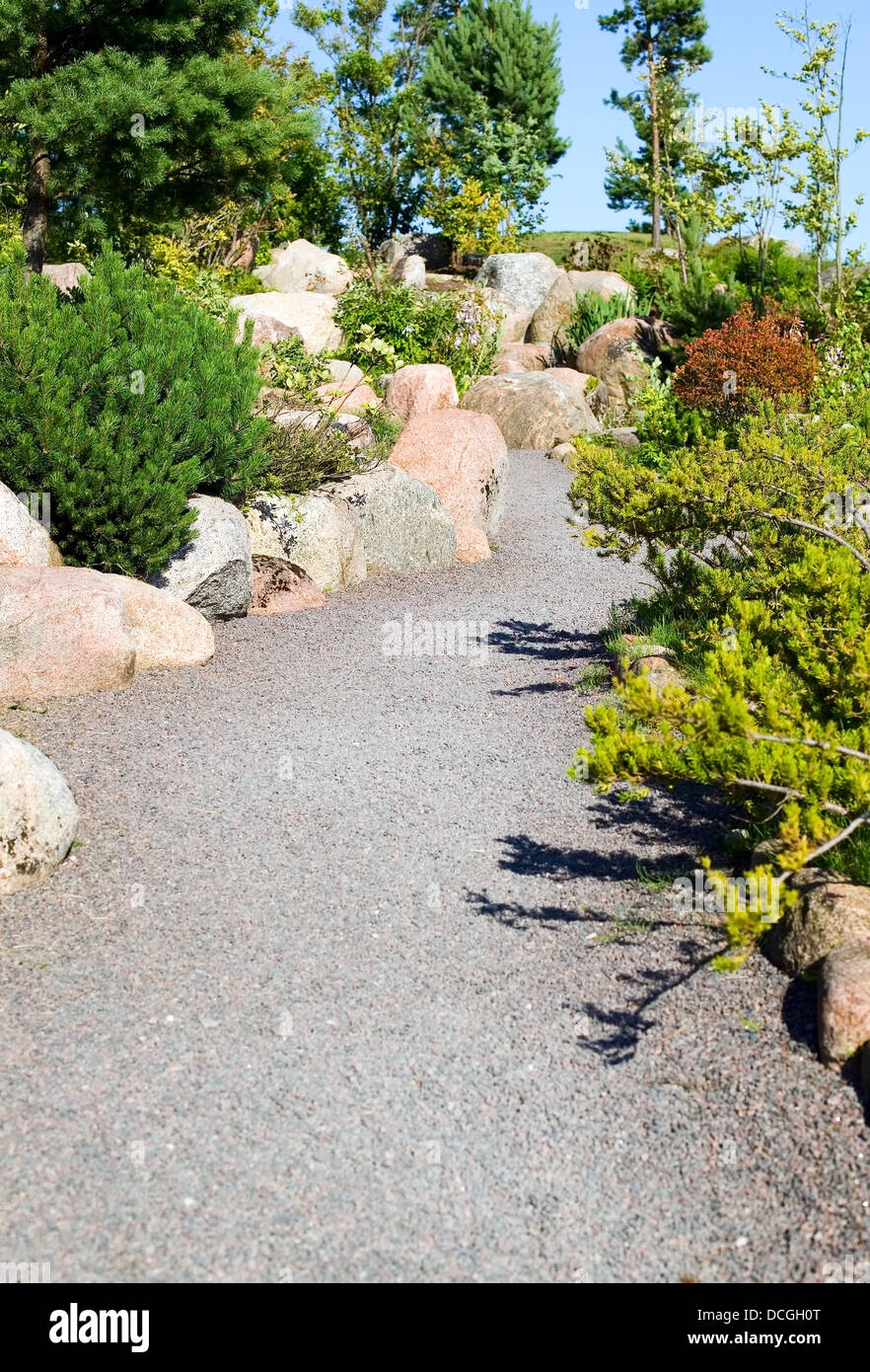 Grass, tree and nature around path with stones Stock Photo - Alamy