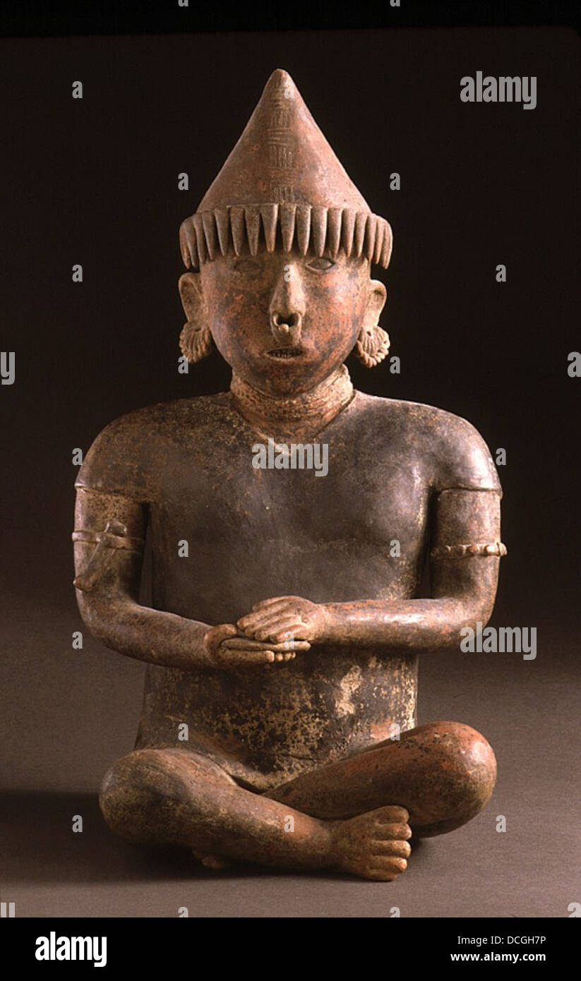 This sculpture represents a seated male figure adorned with a fringed ...