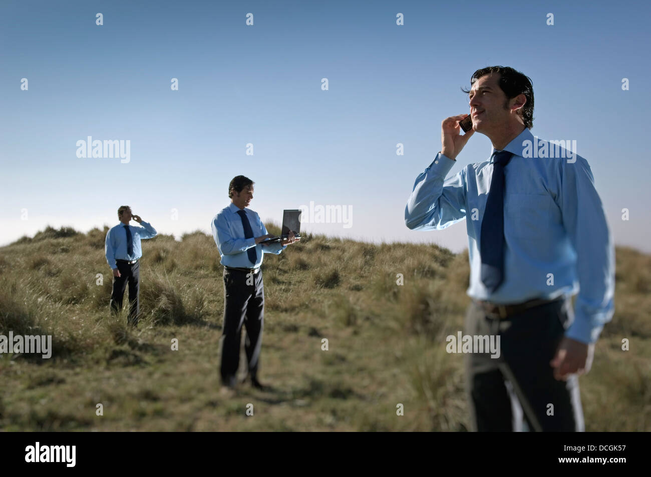 Businessmen In Field With Their Communications Technology Stock Photo ...