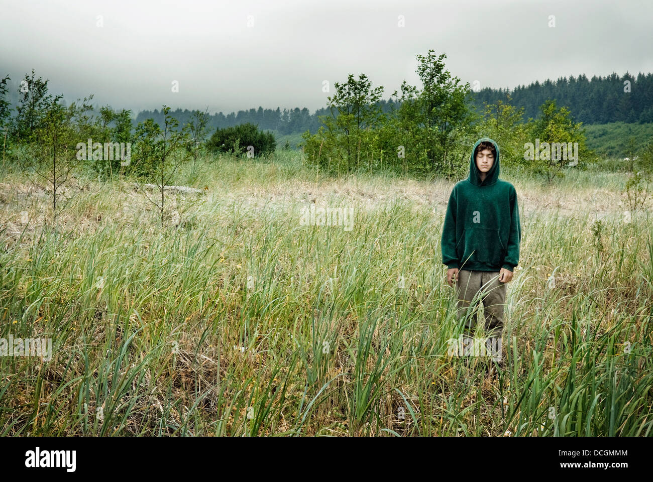 Person Standing In Field In The Rain Stock Photo - Alamy