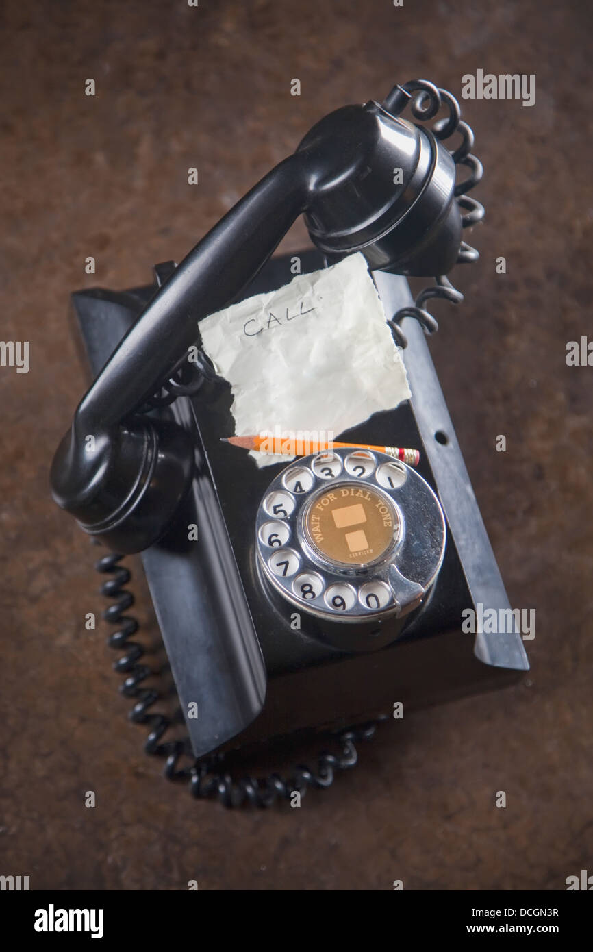 Antique Telephone With A Piece Of Paper And Pencil Stock Photo - Alamy