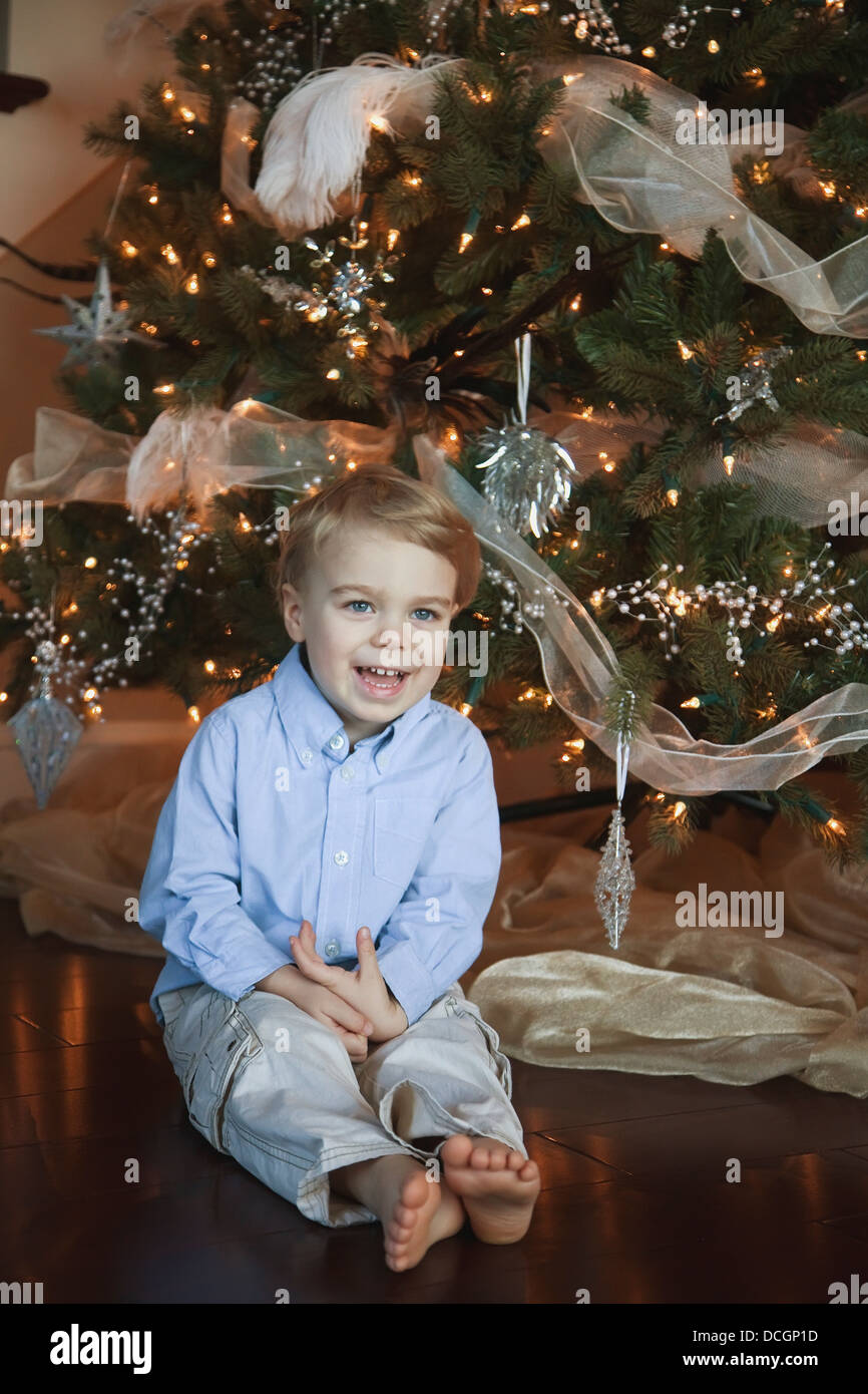 Toddler Sitting Beside Christmas Tree Stock Photo - Alamy