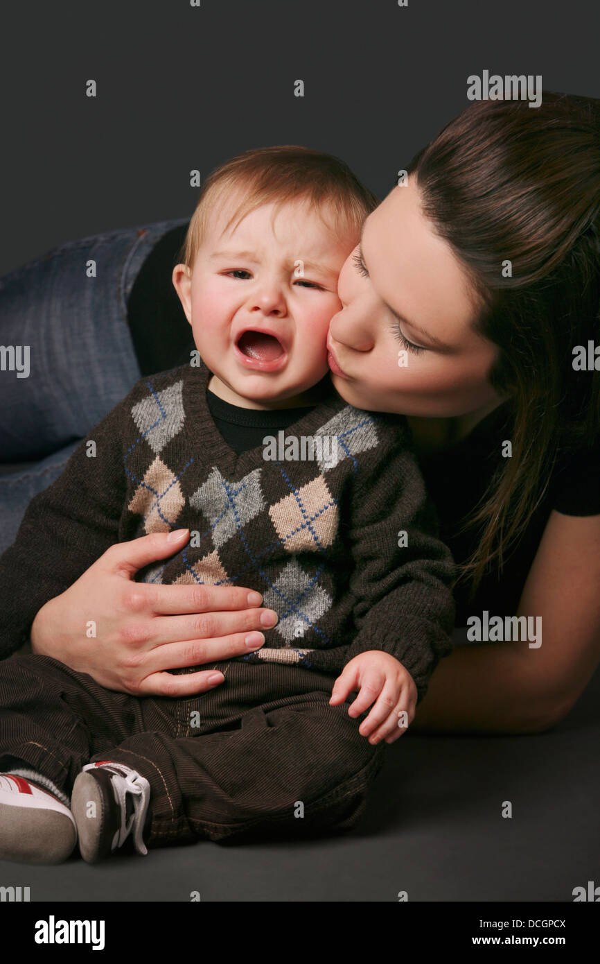 Mother Consoling Her Crying Baby Stock Photo - Alamy