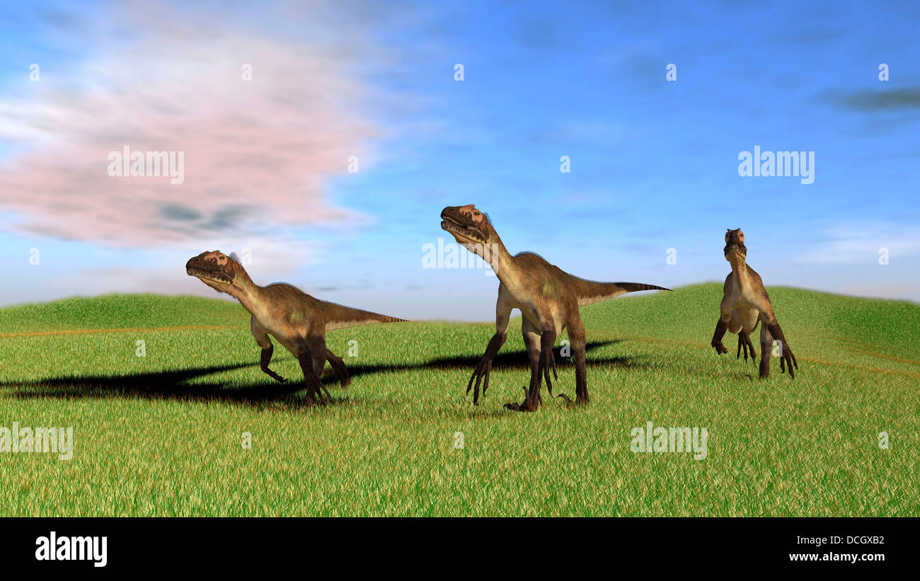 Three Utahraptors running across a grassy field Stock Photo - Alamy