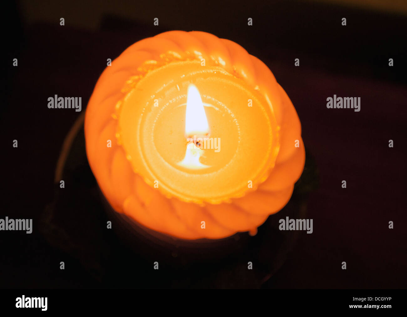 Orange candle burning from the top Stock Photo - Alamy