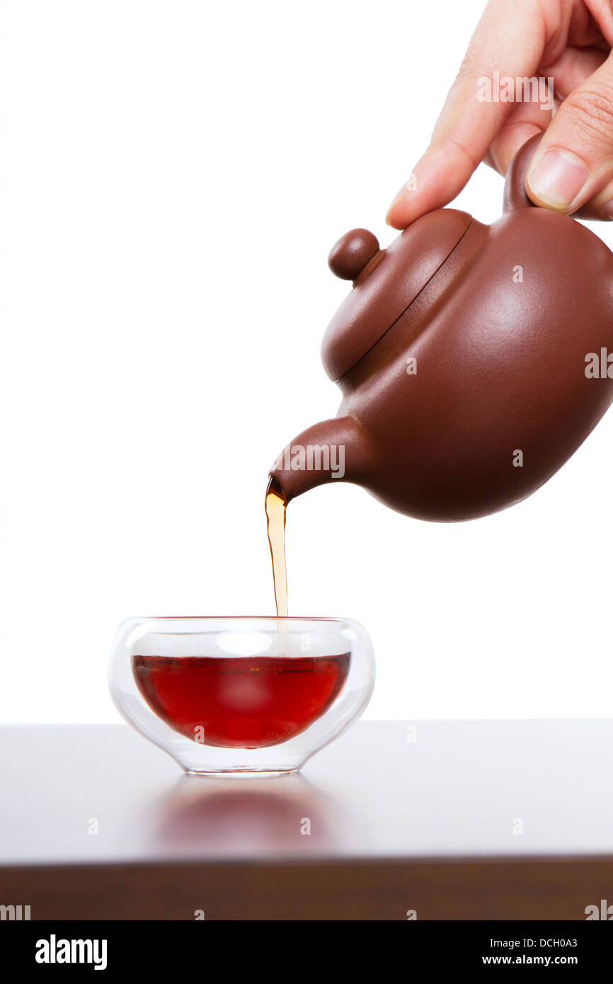 A hand in pouring tea closeup Stock Photo - Alamy
