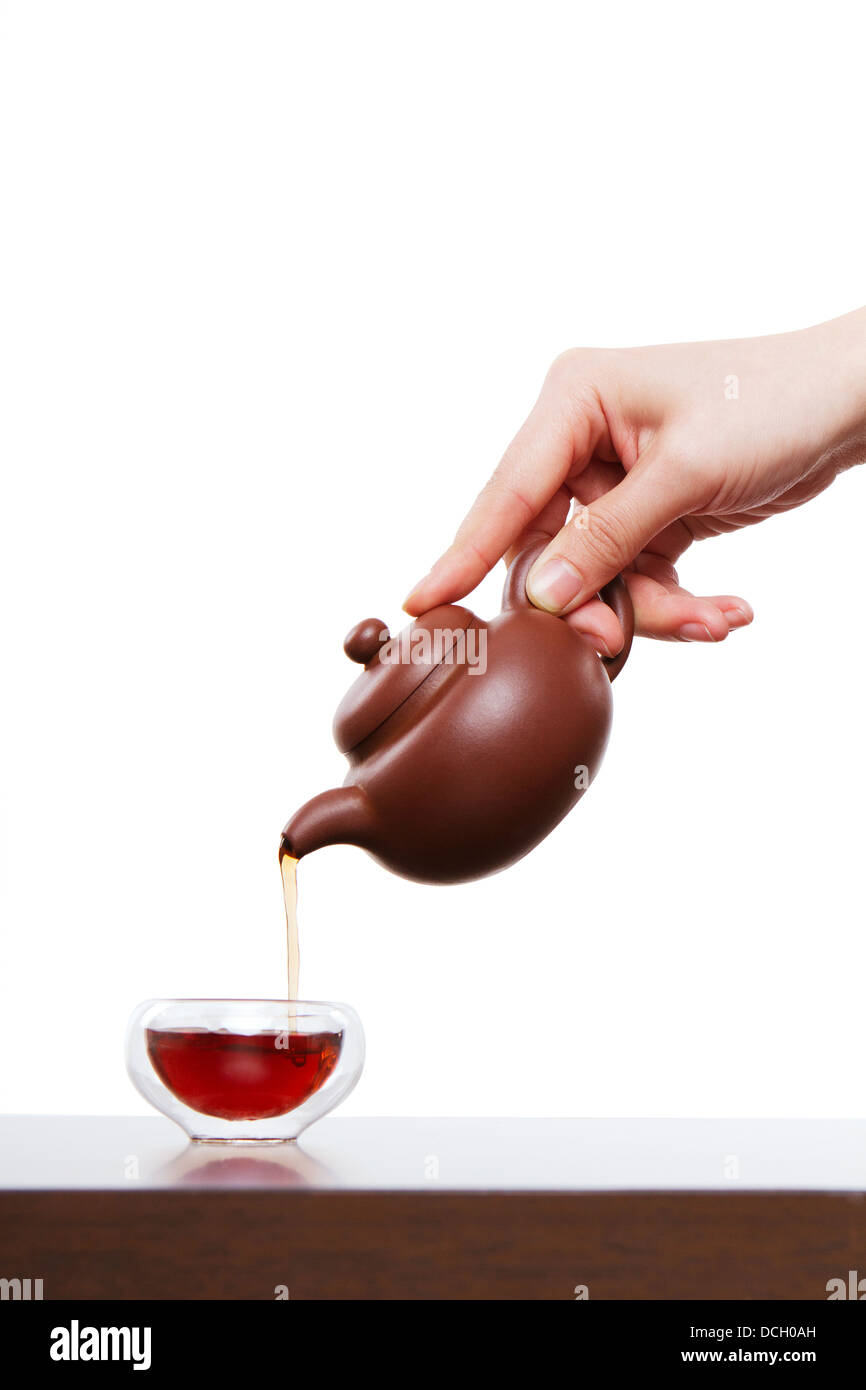 A hand in pouring tea closeup Stock Photo - Alamy
