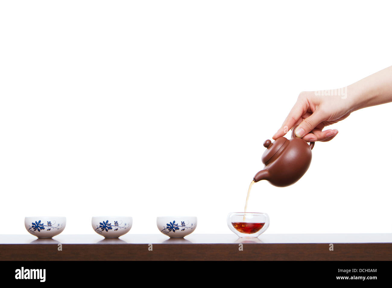 A hand in pouring tea closeup Stock Photo - Alamy