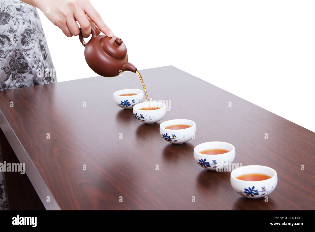 A hand in pouring tea closeup Stock Photo - Alamy