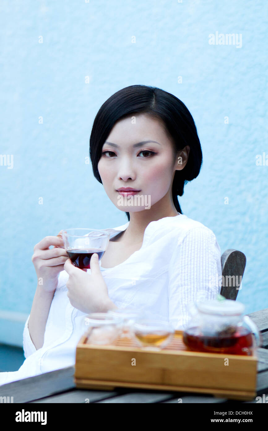 The young woman in the outdoor tea Stock Photo - Alamy