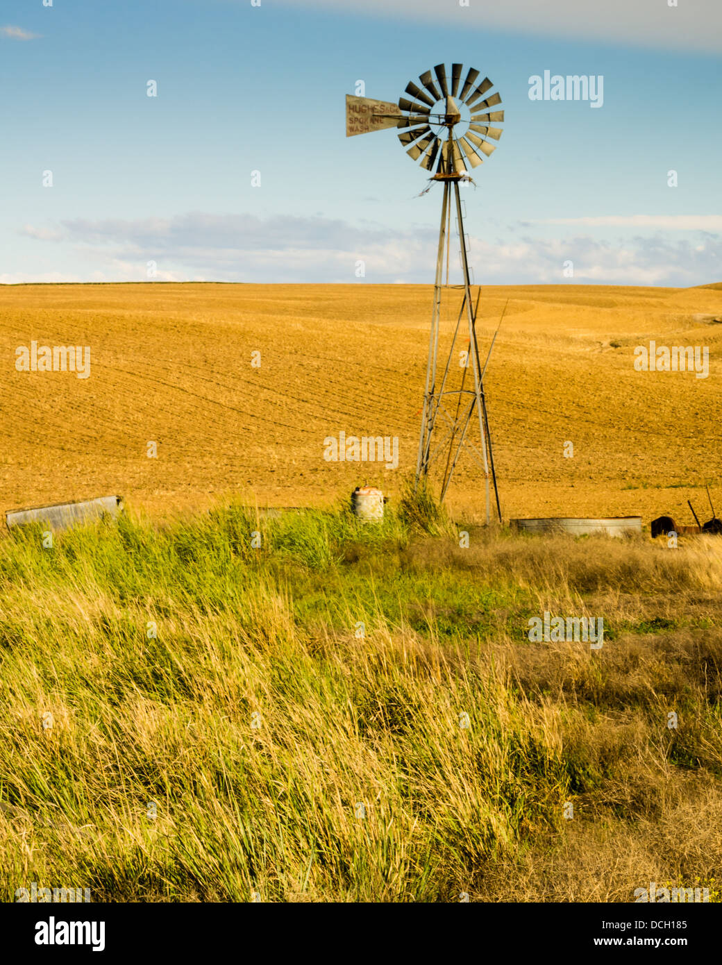 Washington State. A windmill provides water to stock tanks on a farm in ...