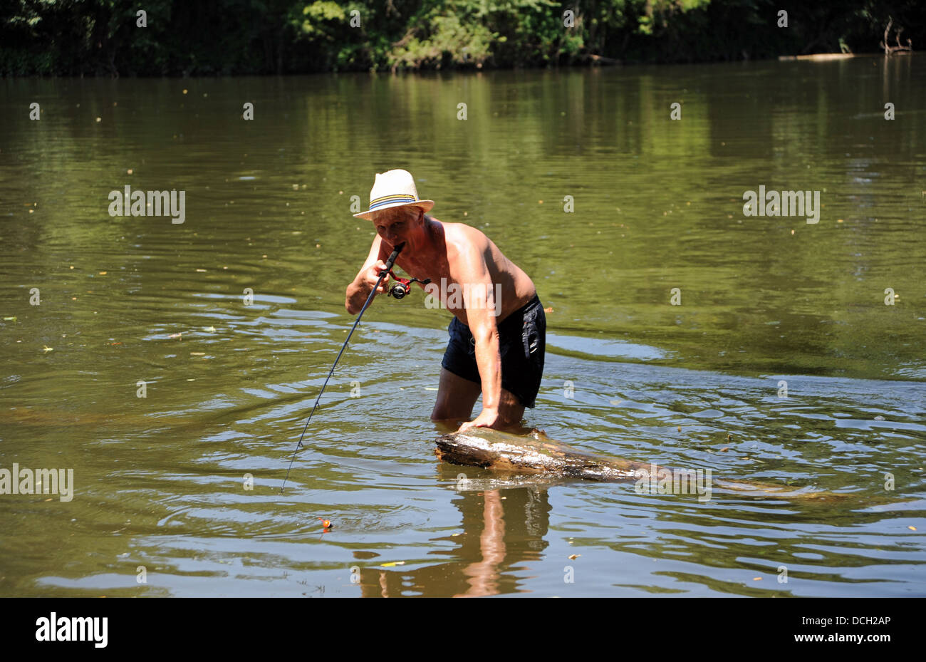Man fishing in the River Lot near Prayssac in the Lot Region or ...