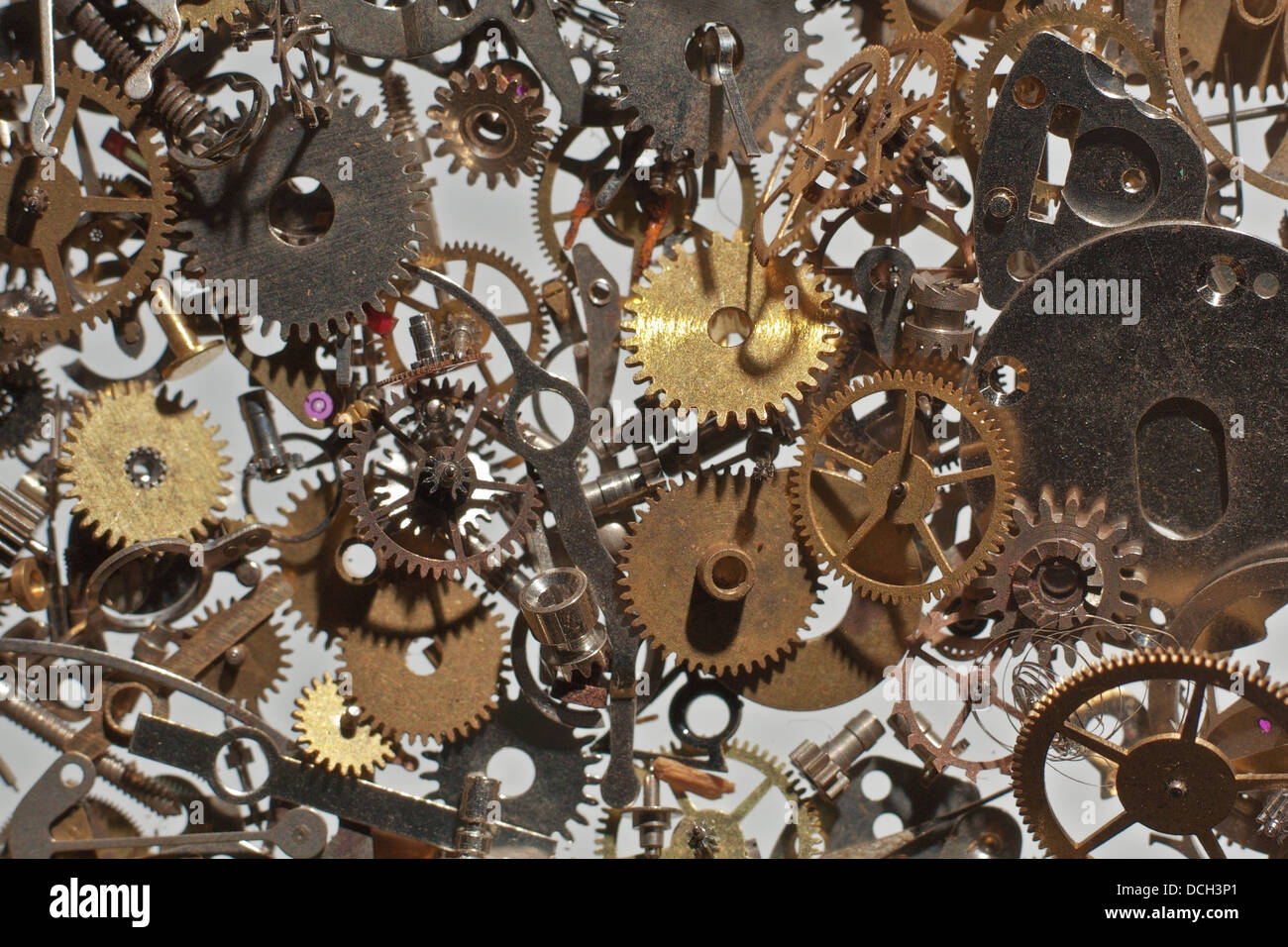 many parts and cog from a watch looking down from above background ...