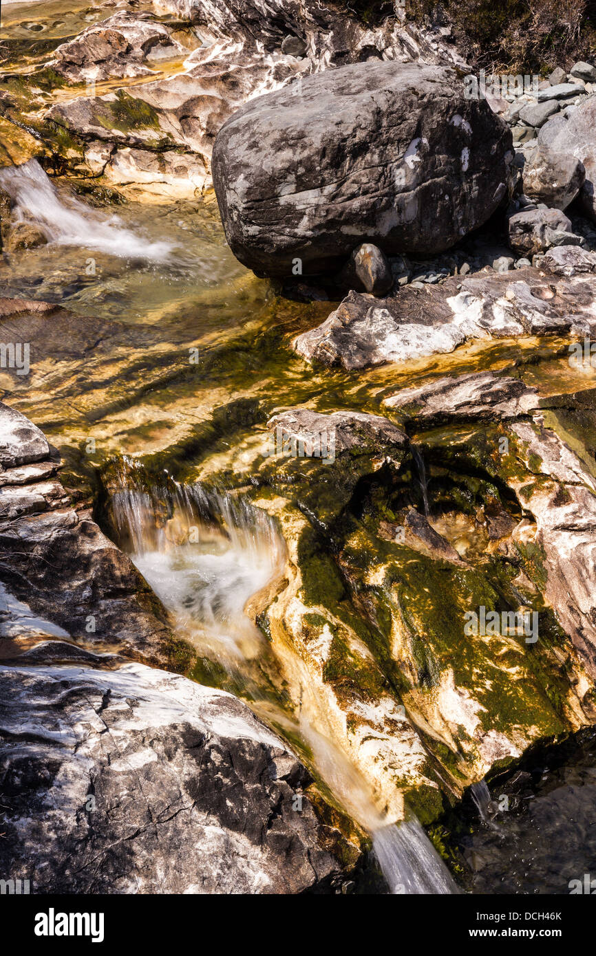 Waterfall flowing over rocky white marble stream bed, Allt Aigeinn ...