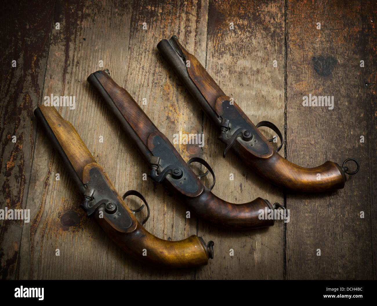 Vintage pistols on wooden background Stock Photo - Alamy