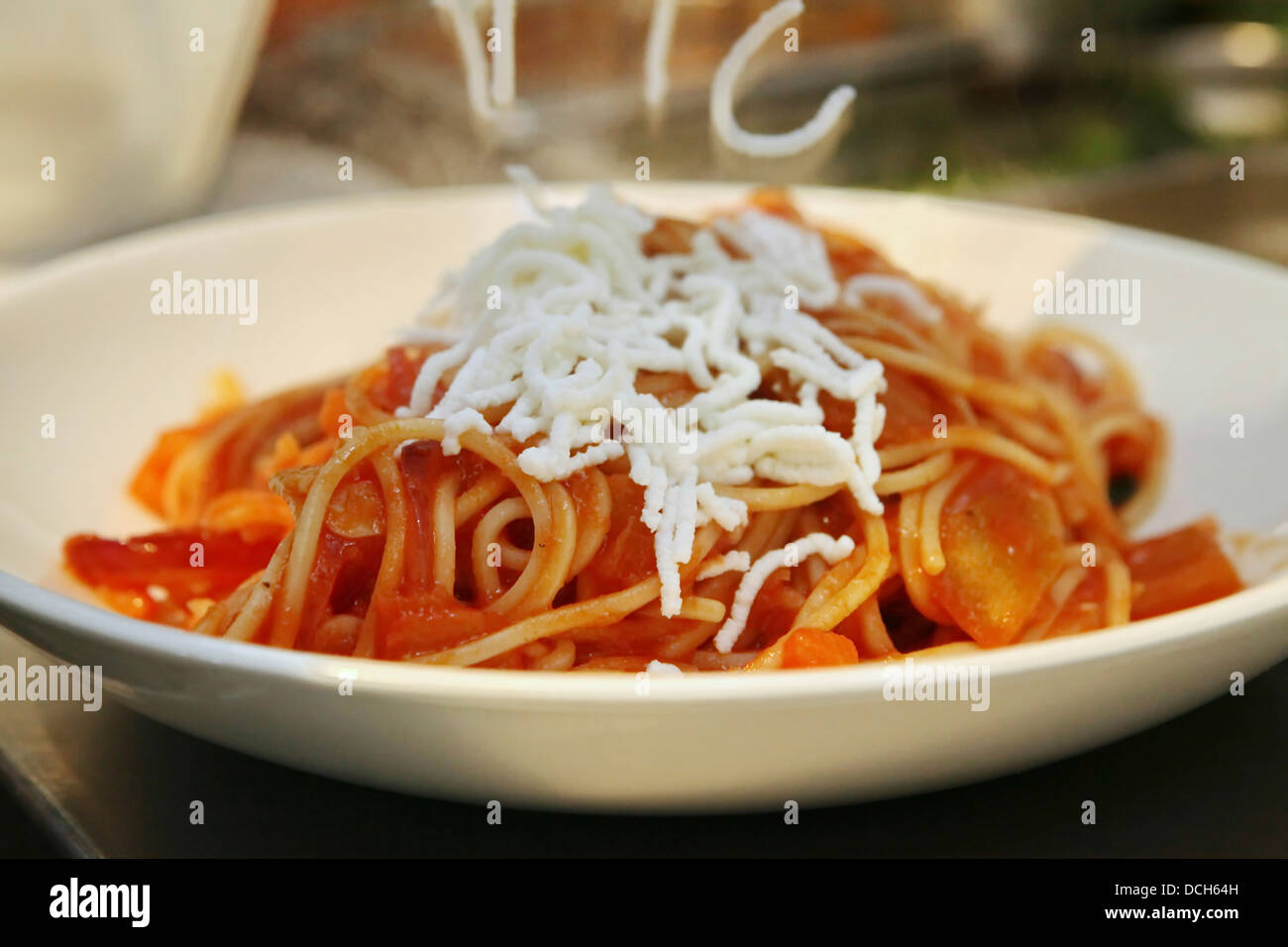 Preparing Spaghetti and marinara sauce adding the Parmesan Cheese Stock ...