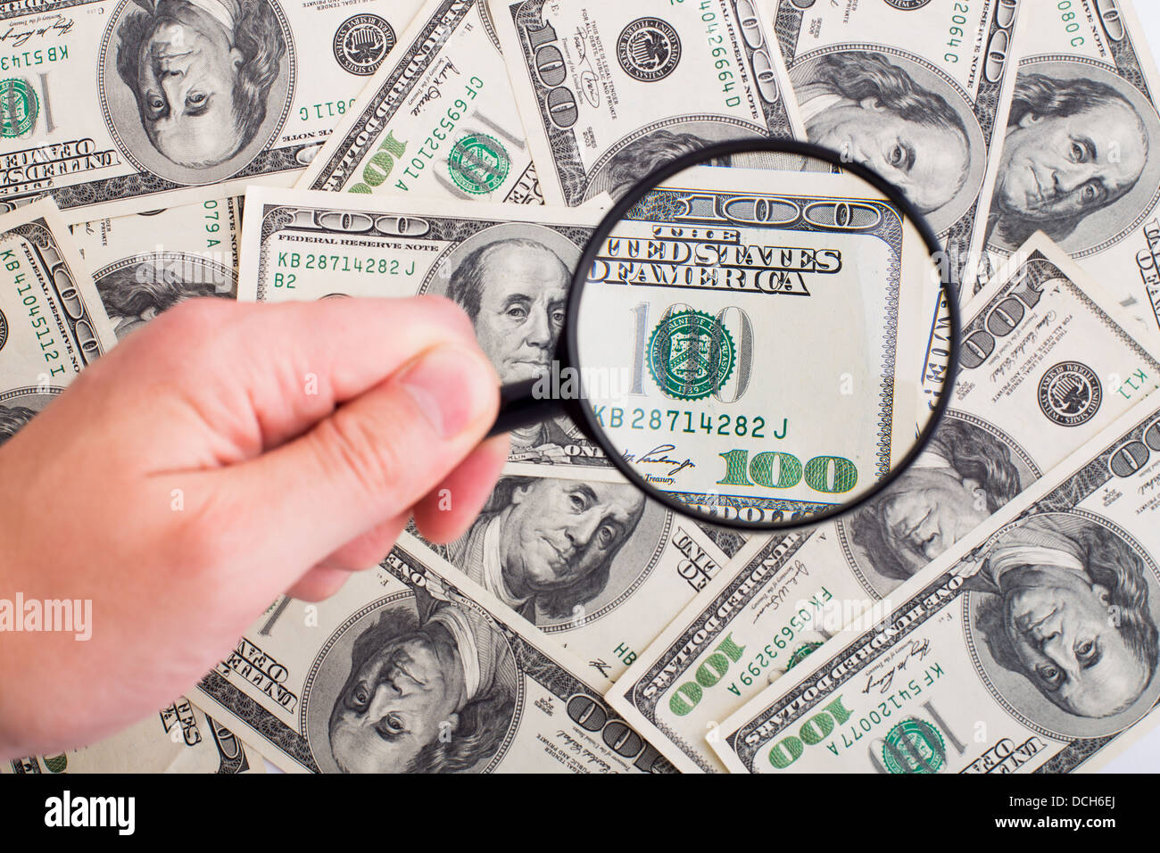 Dollars and black magnifying glass Stock Photo - Alamy