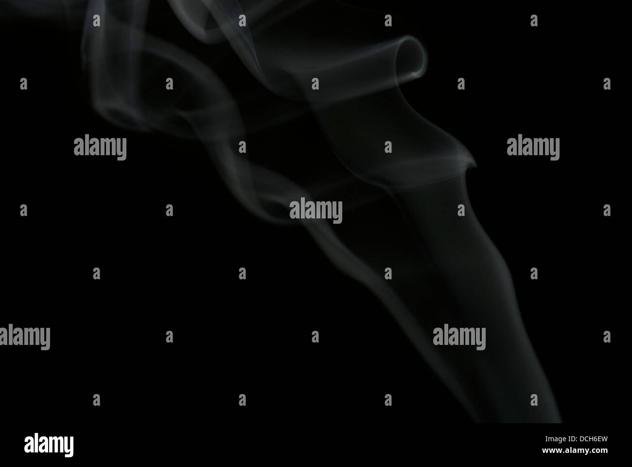 Sensitive incense smoke shape against black background Stock Photo - Alamy