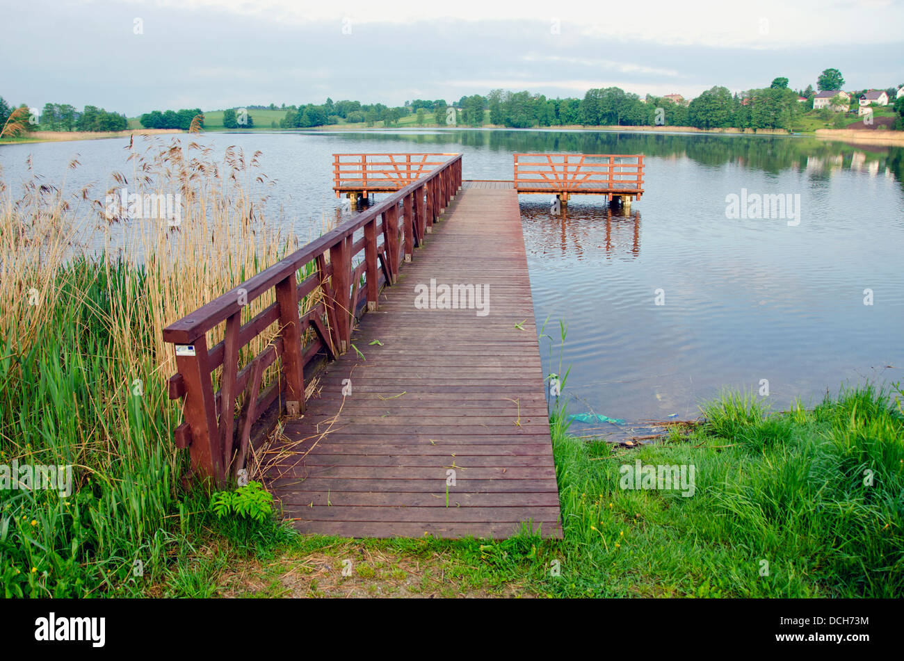 wooden pier on spring resort lake Stock Photo - Alamy