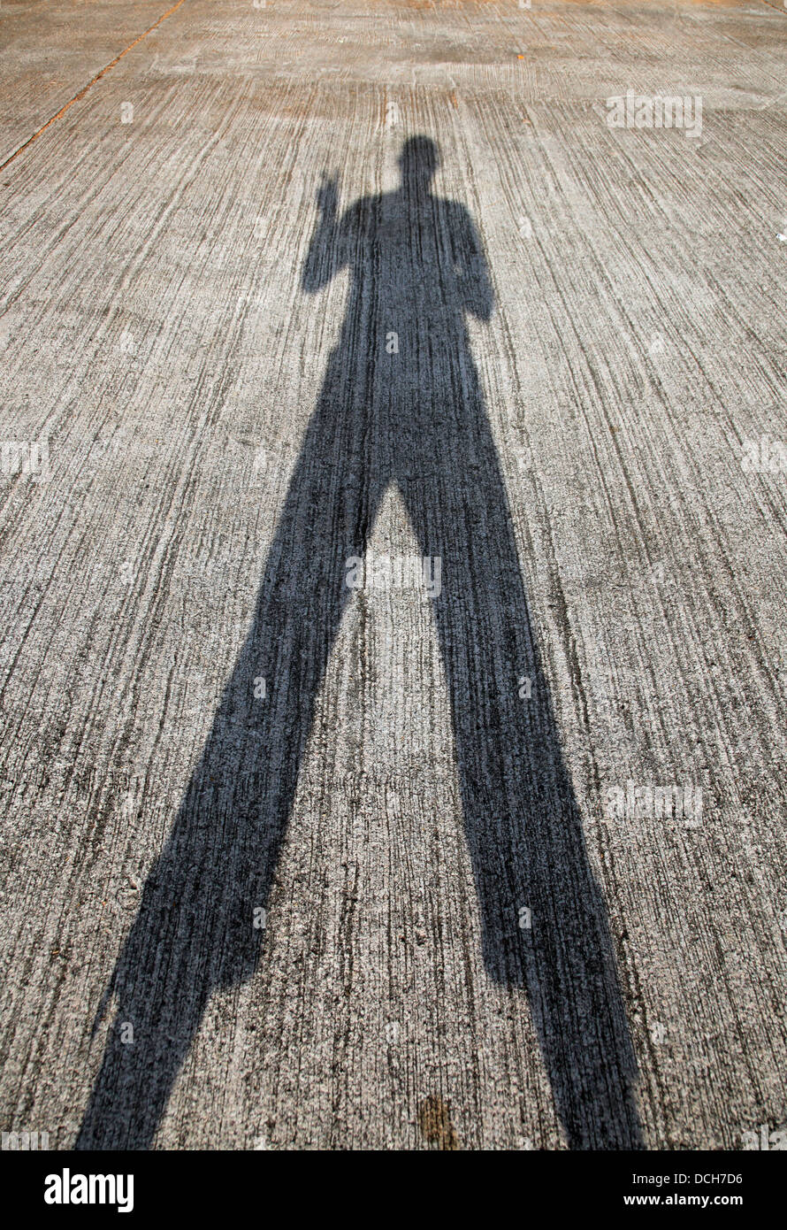 It's a photo of a shadow shape on the ground. It looks very tall or ...