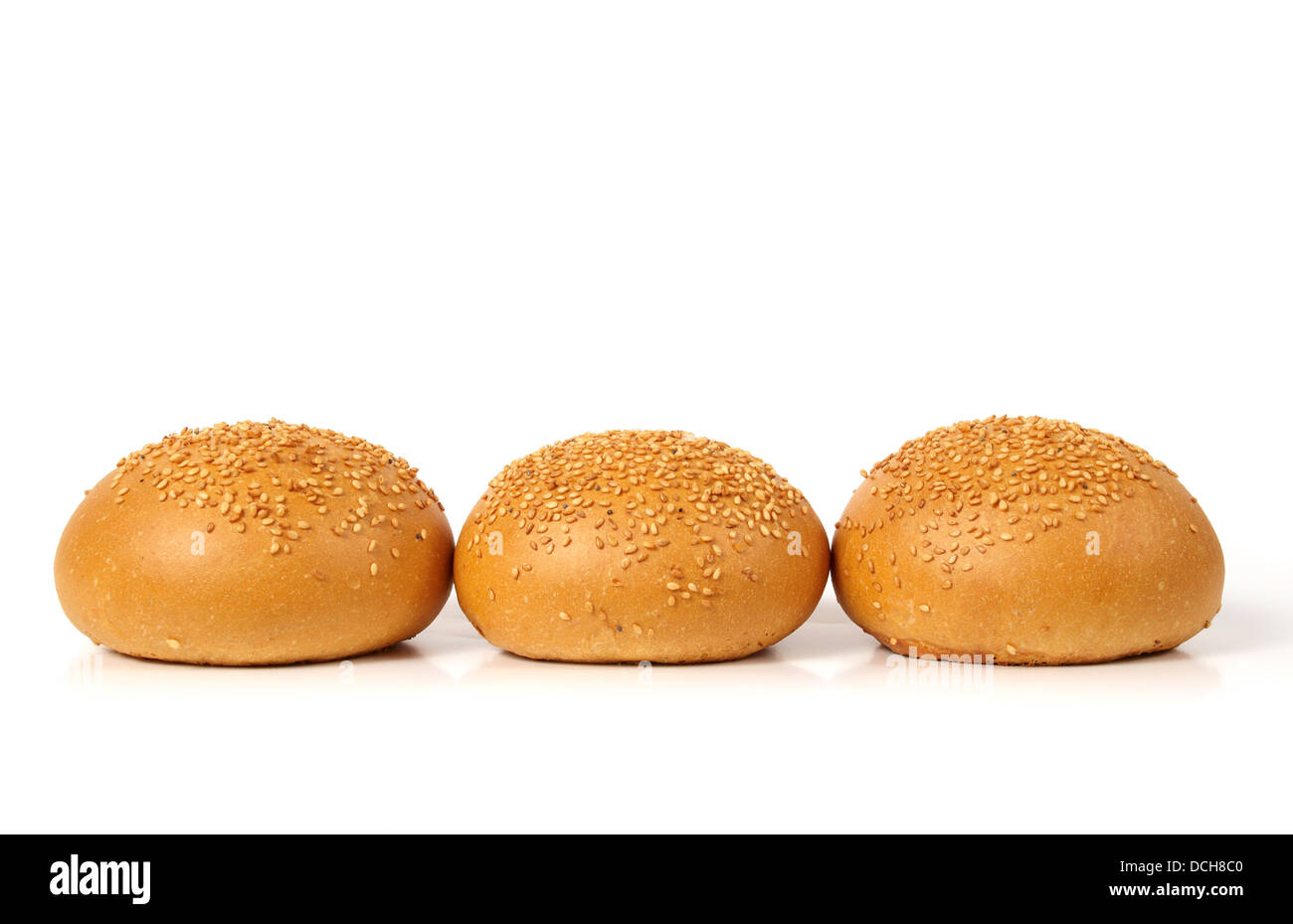 Three sesame seed buns isolated over white Stock Photo - Alamy
