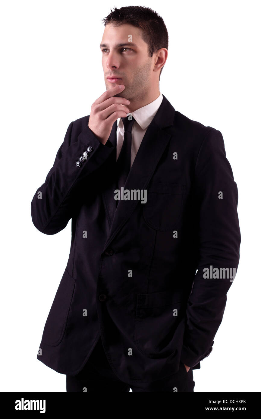 Cute young male man on a dark business suit thinking isolated on a ...