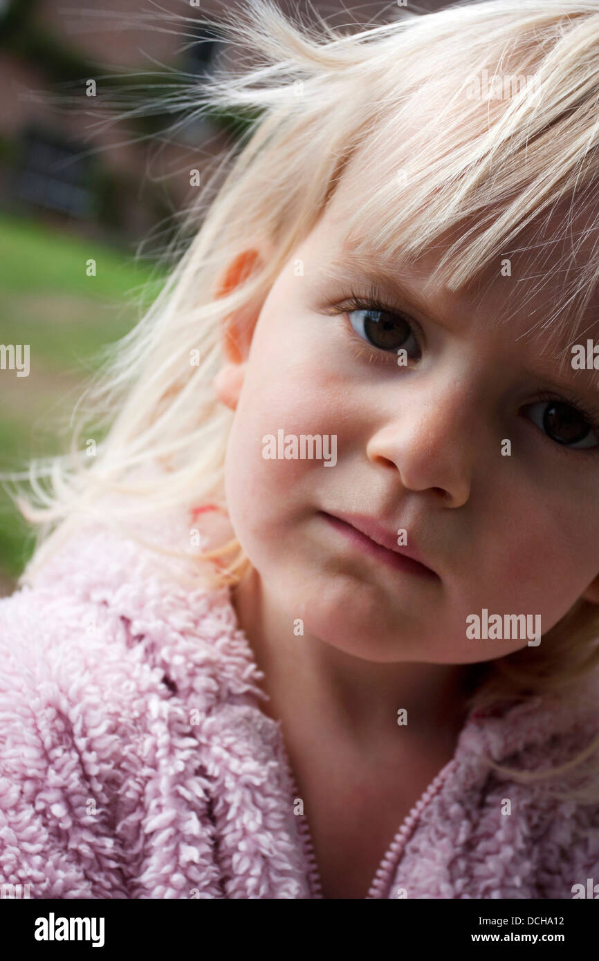 Portrait close up of girl frowning thinking or not happy Stock Photo ...