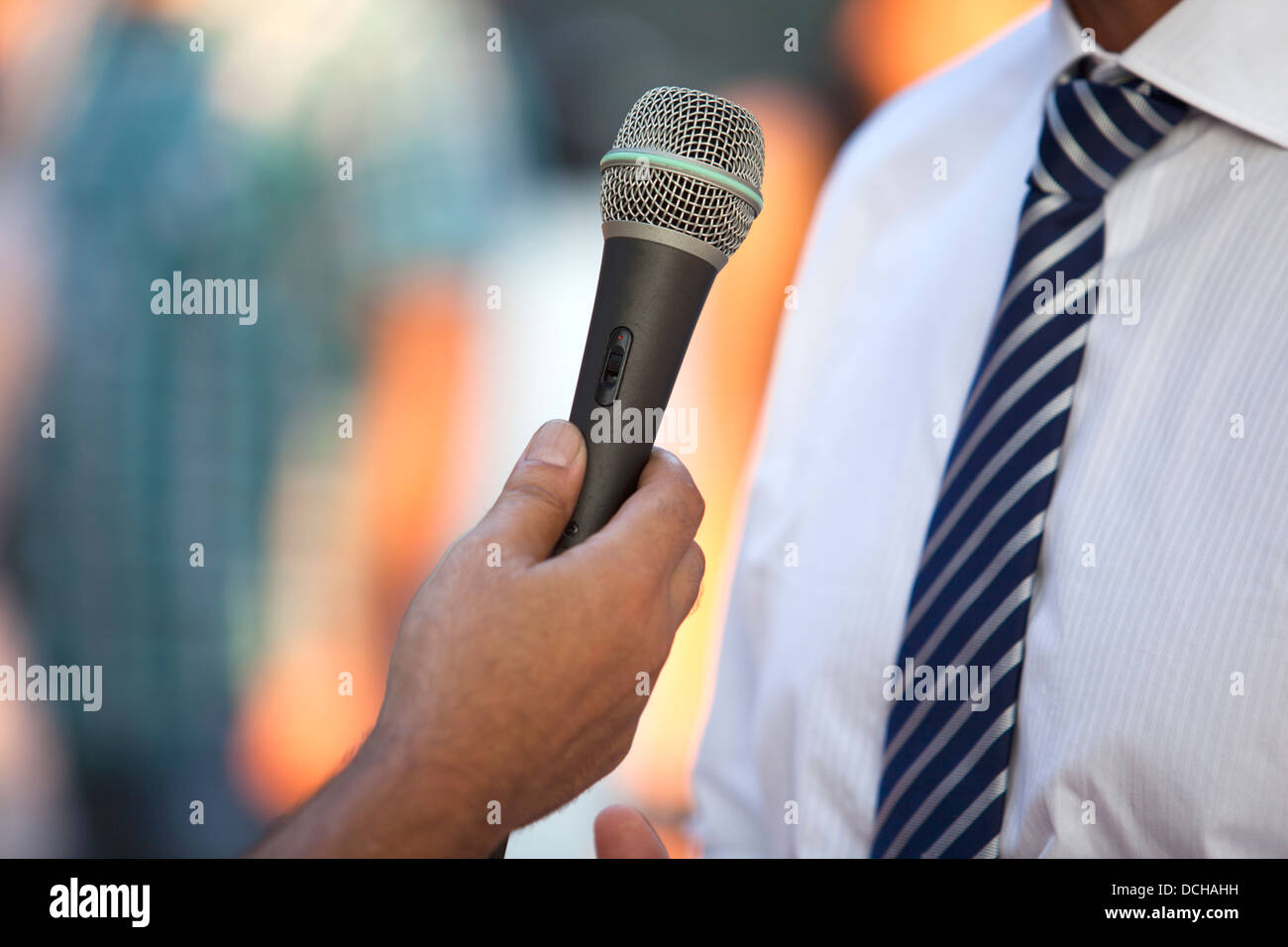 A journalist is making a interview with a microphone Stock Photo - Alamy